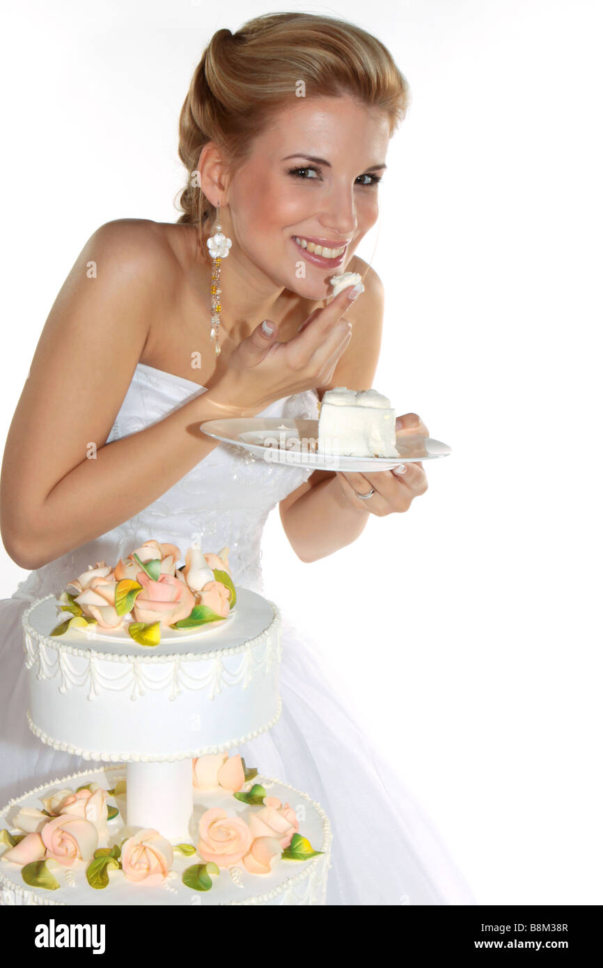 beautiful bride in white wedding dress eating cake Stock Photo - Alamy