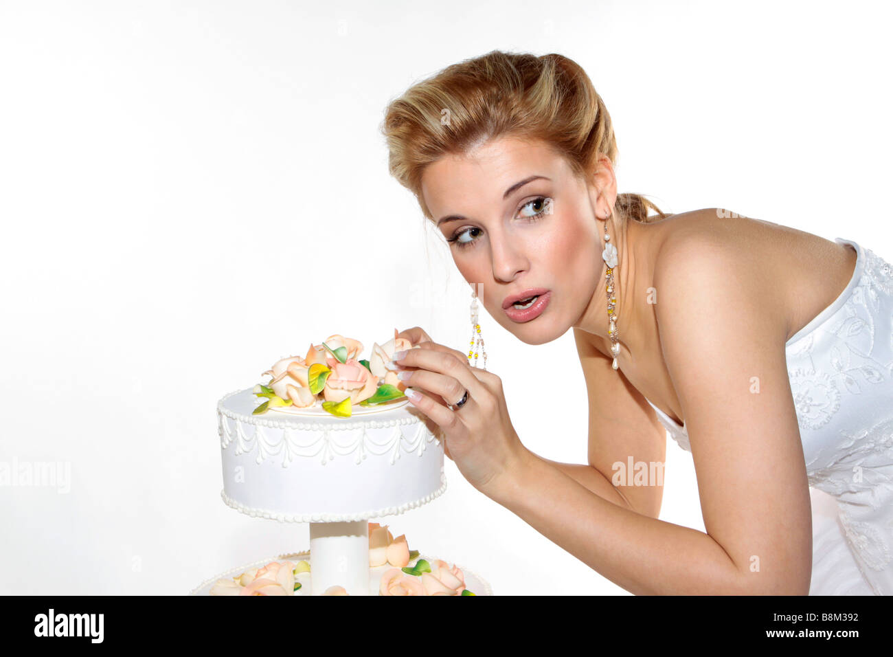 beautiful bride in white wedding dress eating cake Stock Photo - Alamy