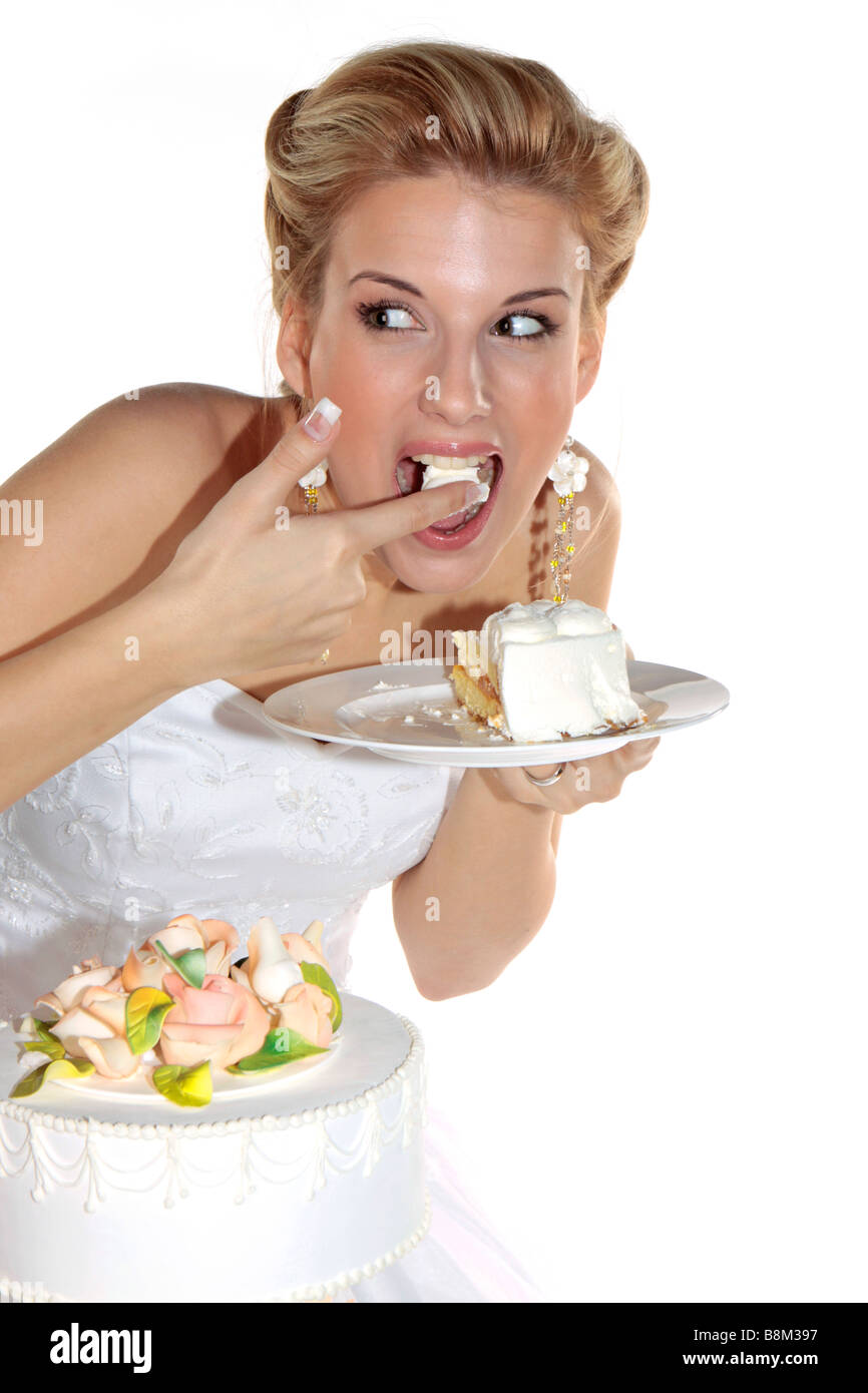 beautiful bride in white wedding dress eating cake Stock Photo - Alamy