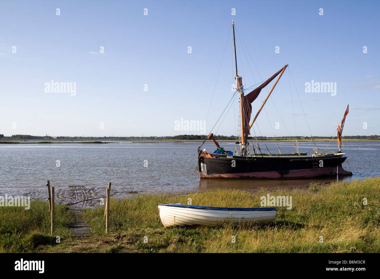 A Victorian spritsail sailing barge at anchor on the River Alde at Iken ...