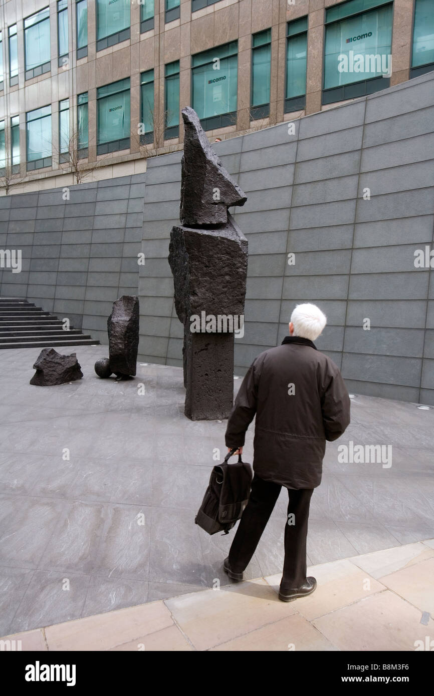 a man looking at statues in broadgate, city of london Stock Photo - Alamy