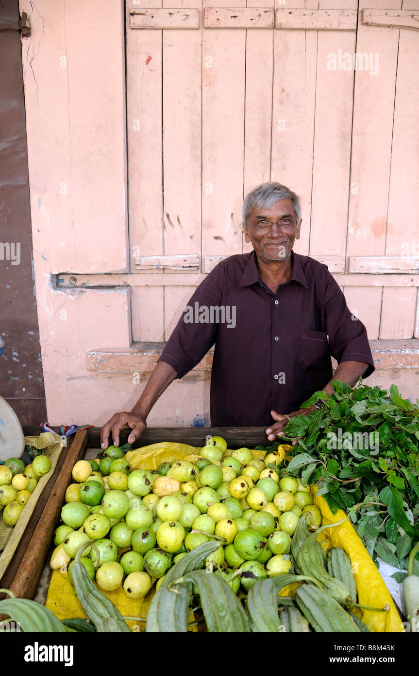 A Mauritian salesman at vegetable stand, Maheboug, Mauritius island ...