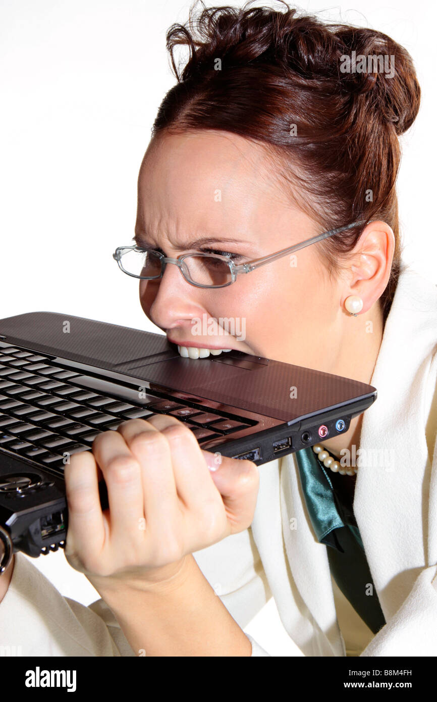 angry businesswoman biting in a notebook Stock Photo - Alamy