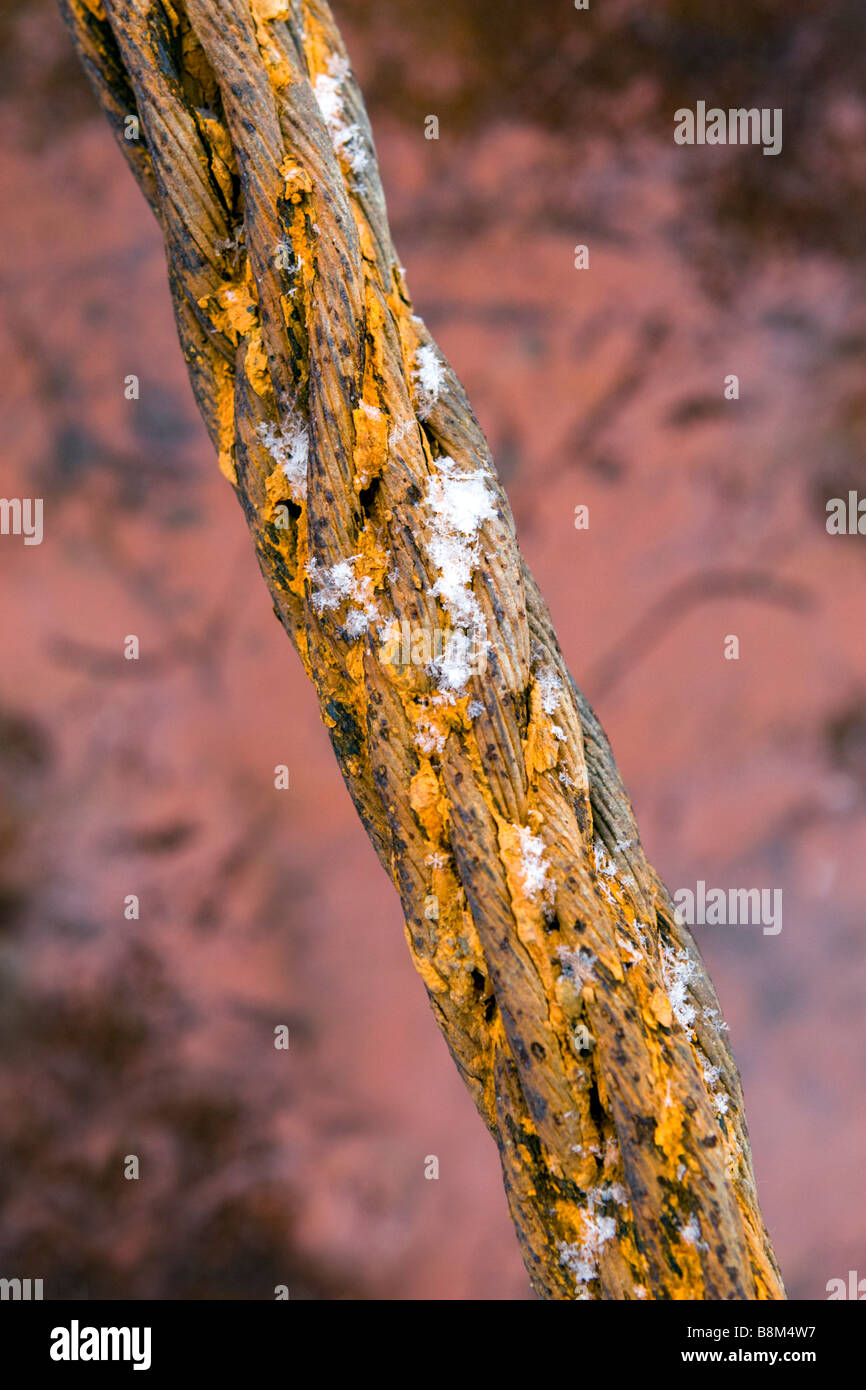 Old strong metal wire hawser over scratched rusty ship hull background ...