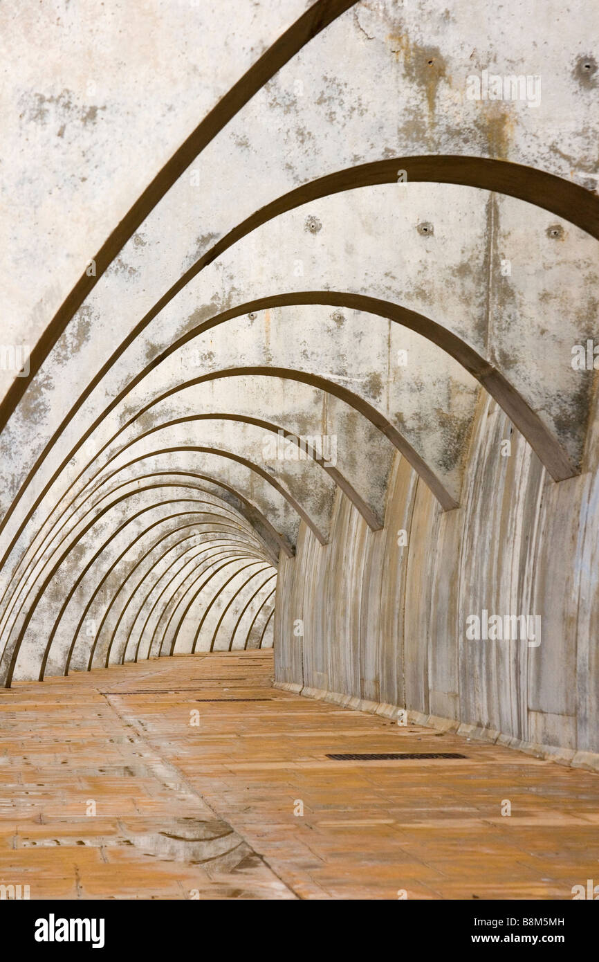 Concrete arches disappearing around corner Stock Photo - Alamy