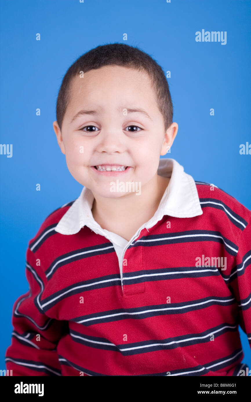 Latino boy studio portrait in front of blue background Stock Photo - Alamy