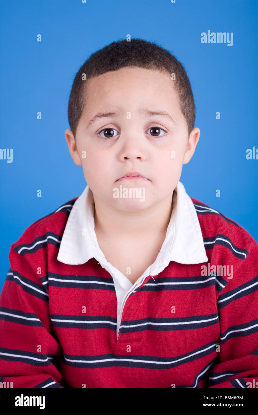 Latino boy studio portrait in front of blue background Stock Photo - Alamy