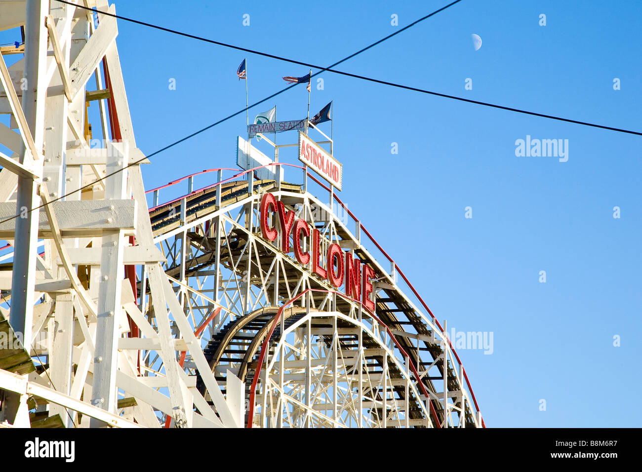 Moon and power lines intersect around the Cyclone roller coaster at ...