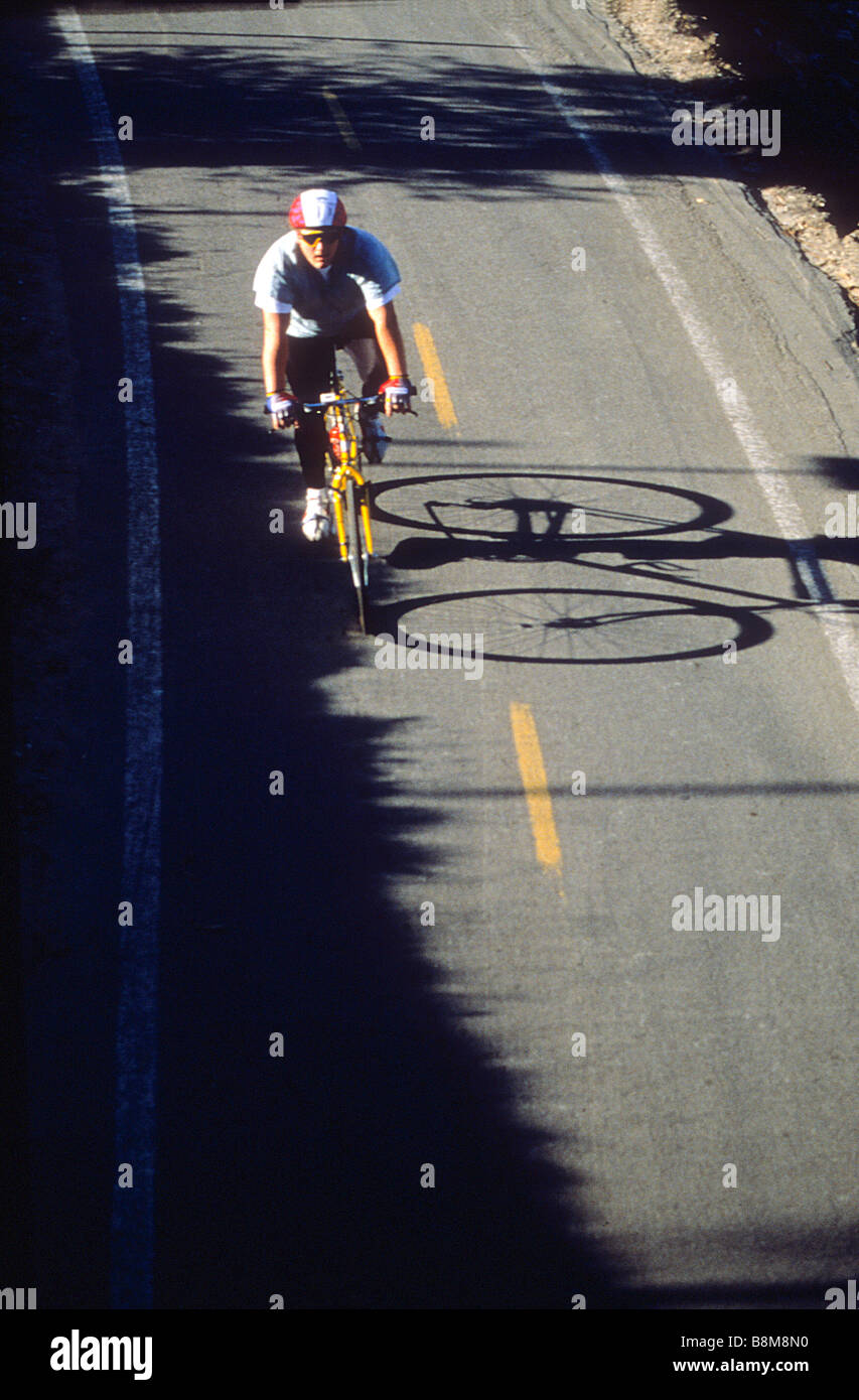 Cyclist races his shadow down bike path in Anaheim, California, USA Stock Photo - Alamy