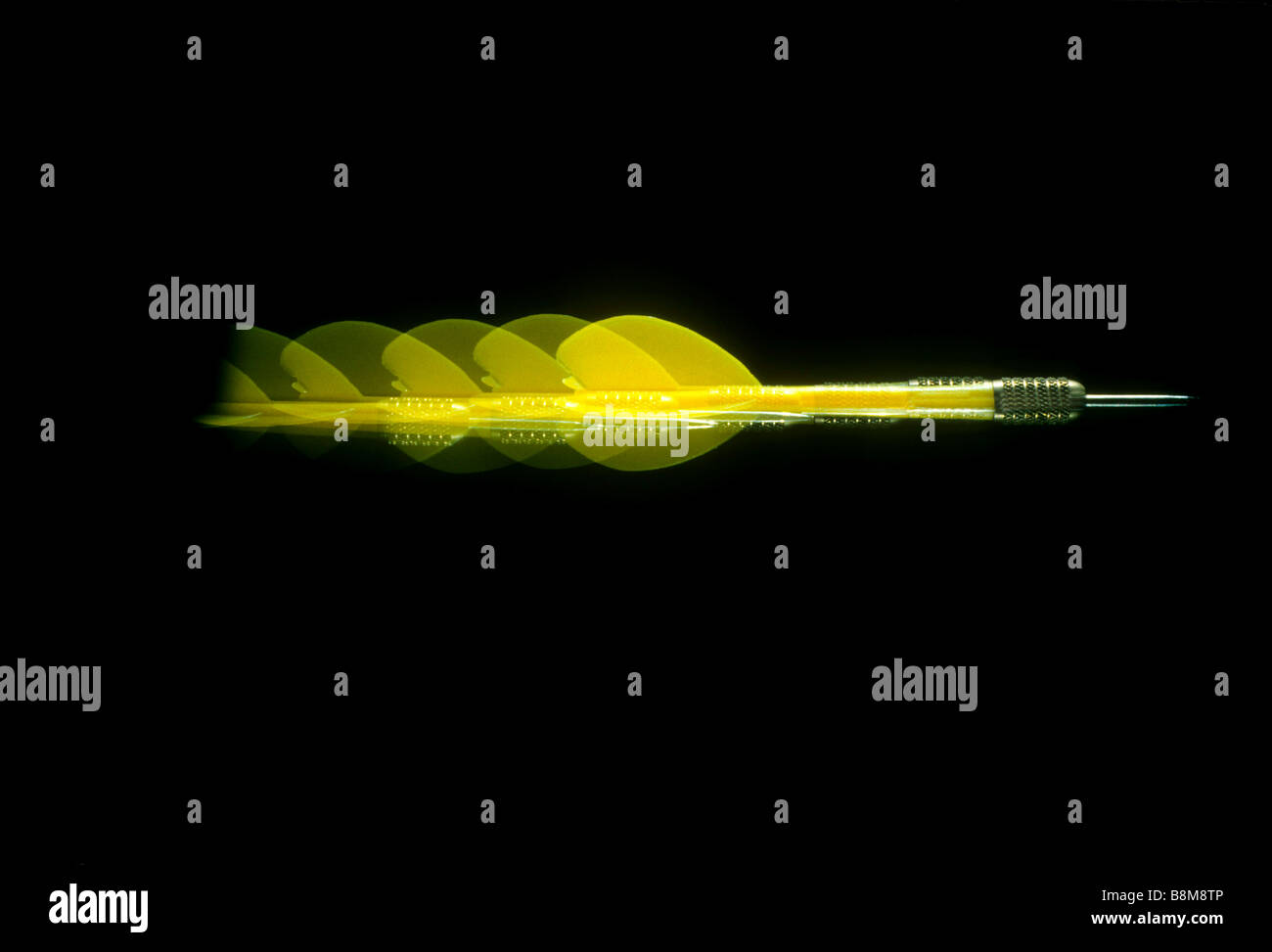 Yellow dart flies through air Stock Photo - Alamy