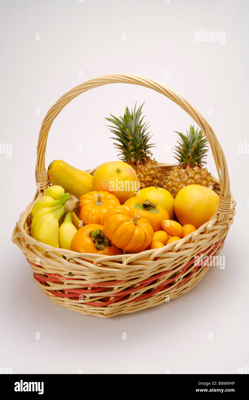 Close up of a stack of yellow fresh fruits and vegetables in a basket ...