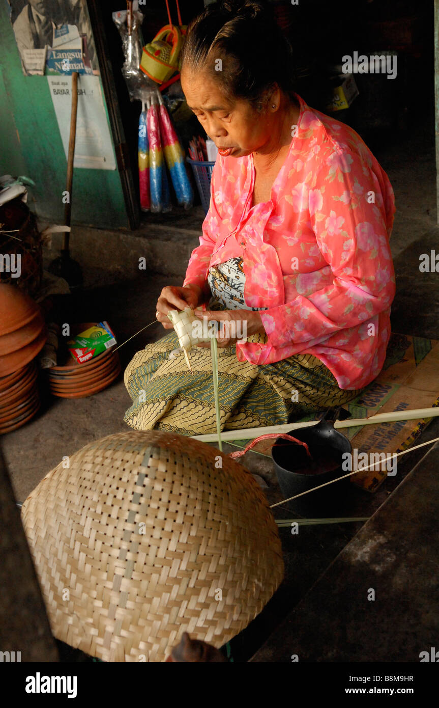 Bali aga old woman weaving fish with dried coconut leaves,Bali ...