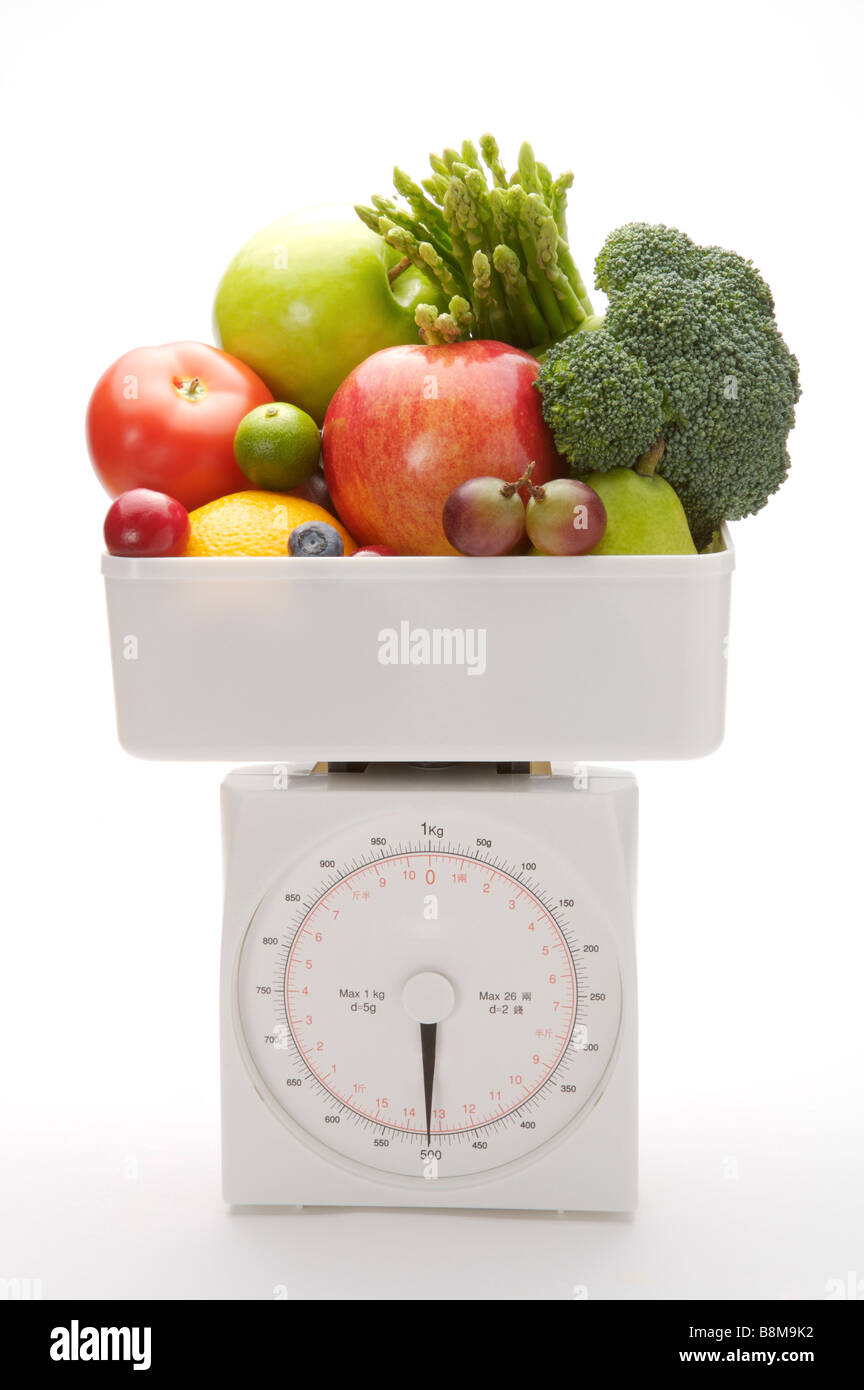 A stack of fruits and vegetables on the weight scale close up Stock ...