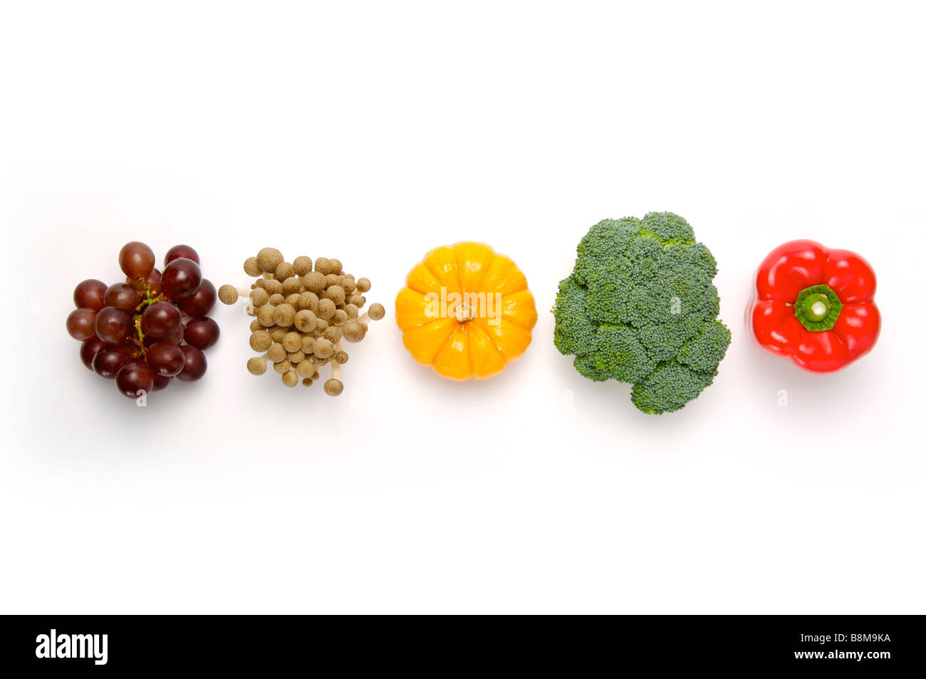 Different fruits and vegetables in a row close up Stock Photo - Alamy