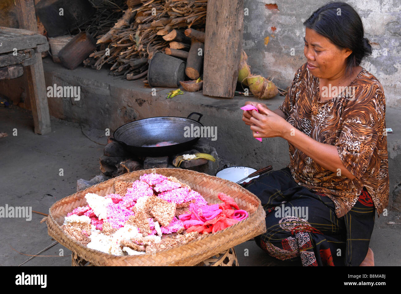 Balinese aga woman is cooking sweet cryspy for Galungan festival,Bali ...