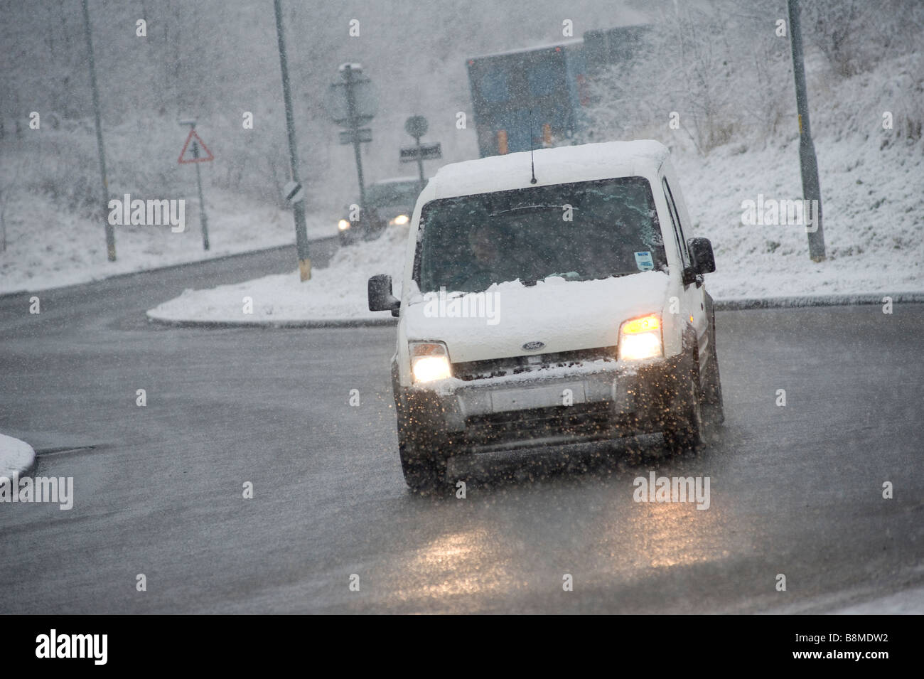 Driving a white ford van through snow and ice to make deliveries on a ...