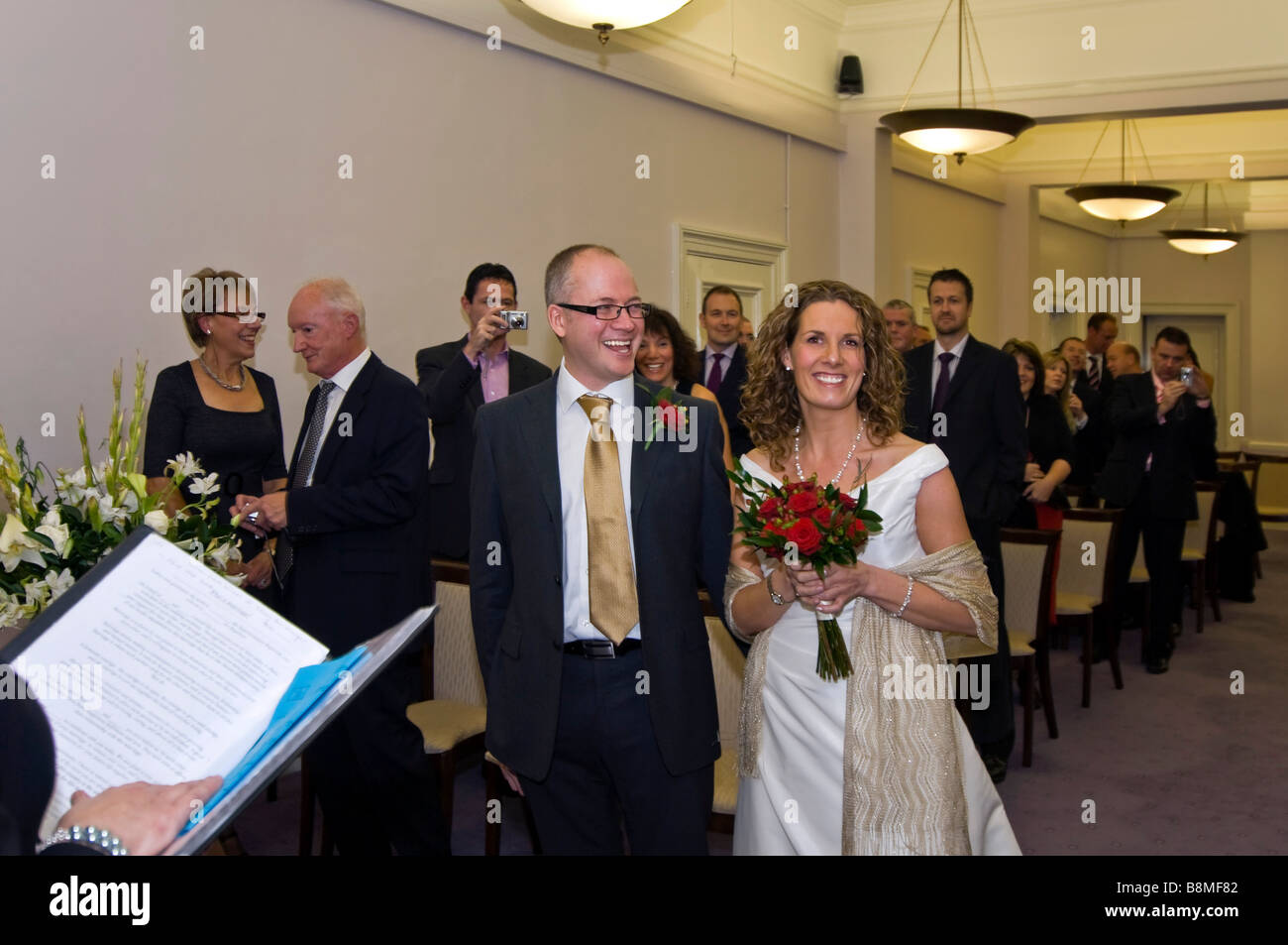 Horizontal wide angle portrait of the bride and groom standing together ...