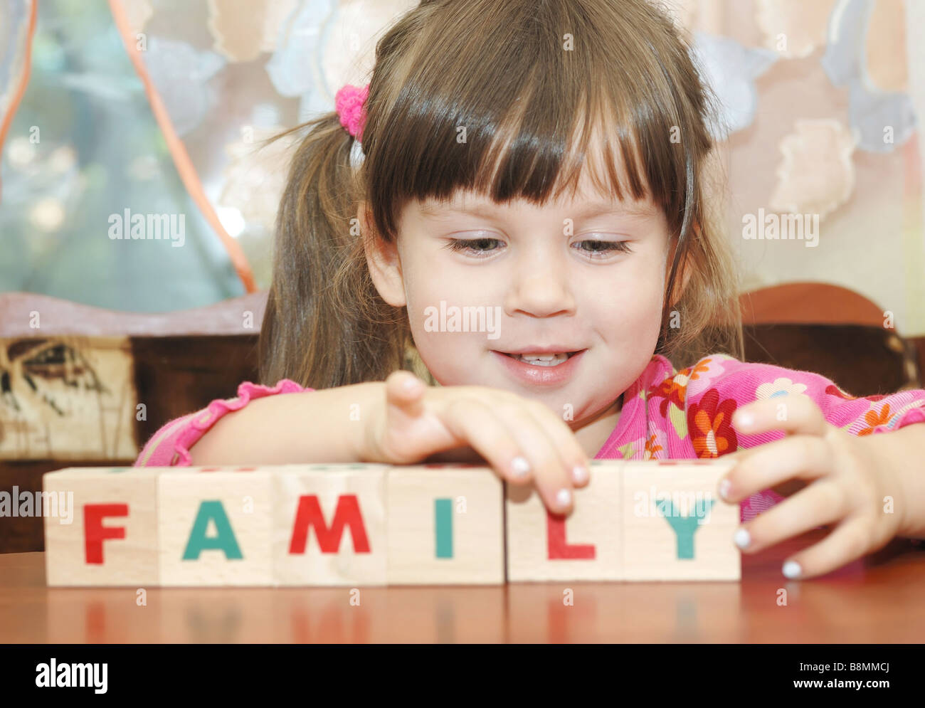 The girl and toy cubes The child collecting a word family from cubes ...
