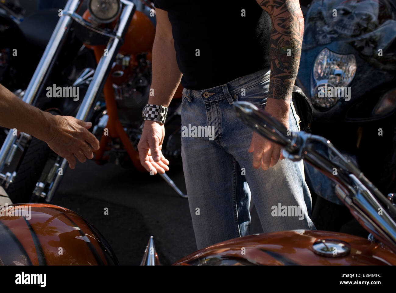 Two men are about to shake hands--or are they? One is a motorcycle ...