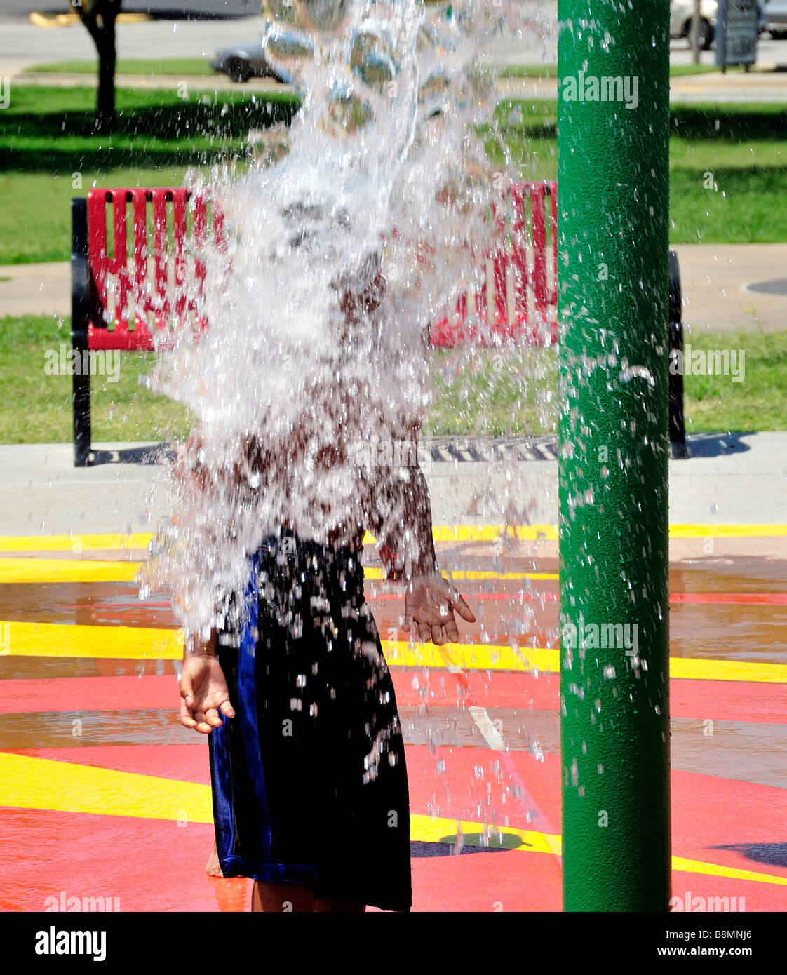 A Hispanic boy is hit with falling water at a water park. Oklahoma City ...
