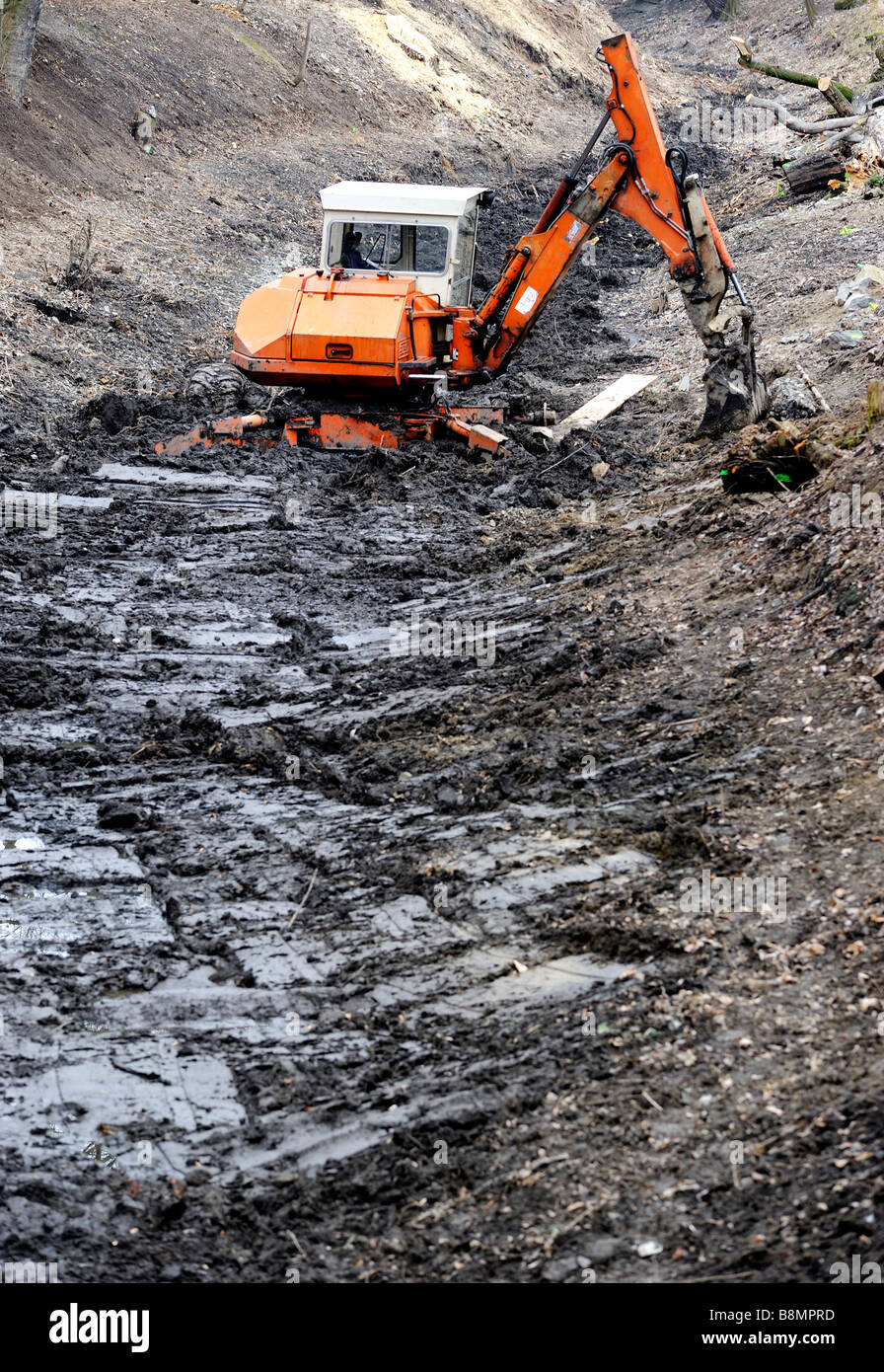 Excavator dredging sediment mud from river Stock Photo - Alamy