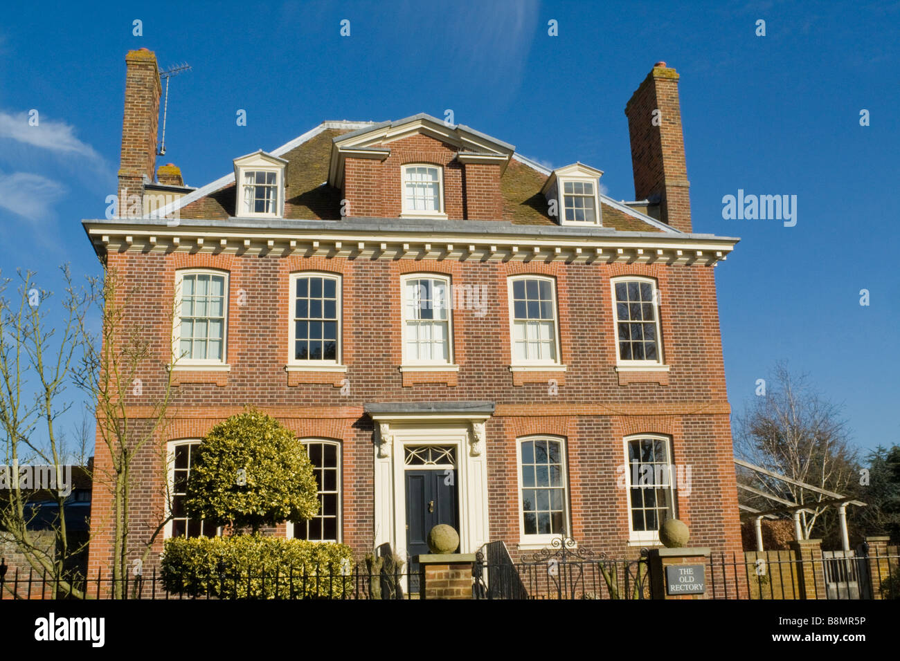 Large georgian house overlooks village green Stock Photo - Alamy