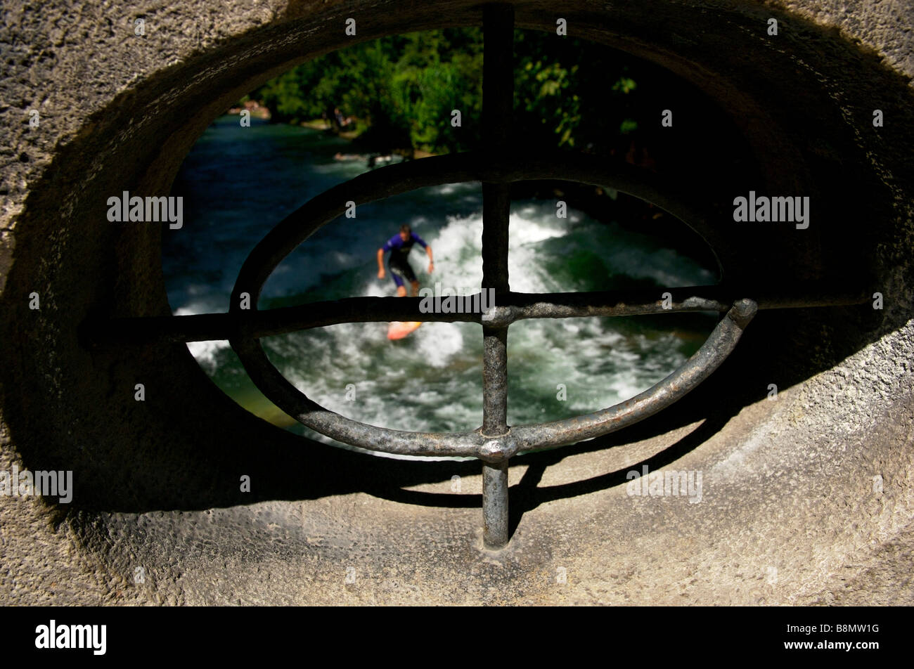 Looking through hole in bridge at a Surfer riding a standing wave on ...