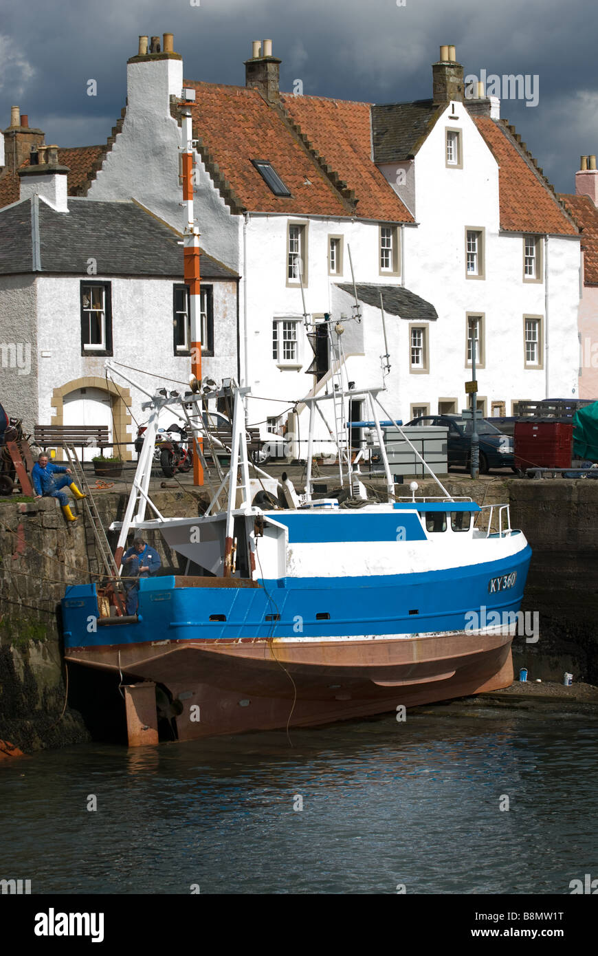photograph of fishing boat in harbour for maintenance Stock Photo - Alamy