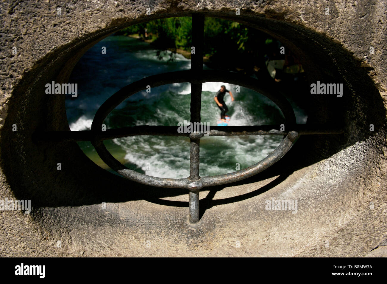 Looking through hole in bridge at a Surfer riding a standing wave on ...