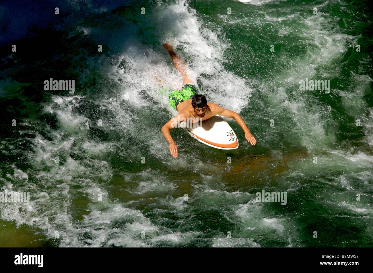 Surfer riding standing wave on the Eisbach river Munich Bavaria Germany ...