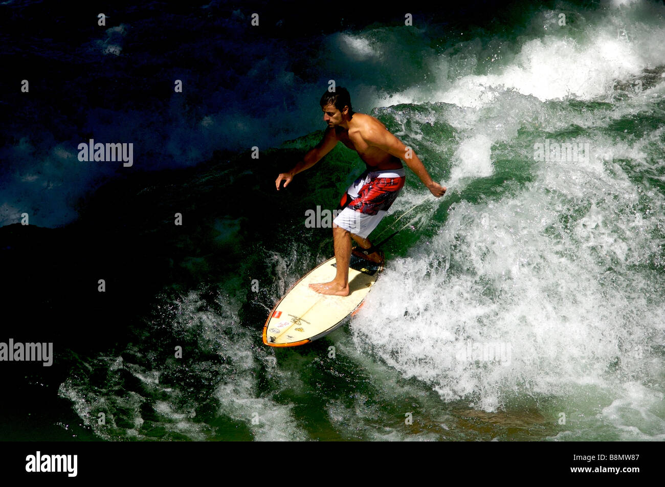 Surfer riding standing wave on the Eisbach river Munich Bavaria Germany ...