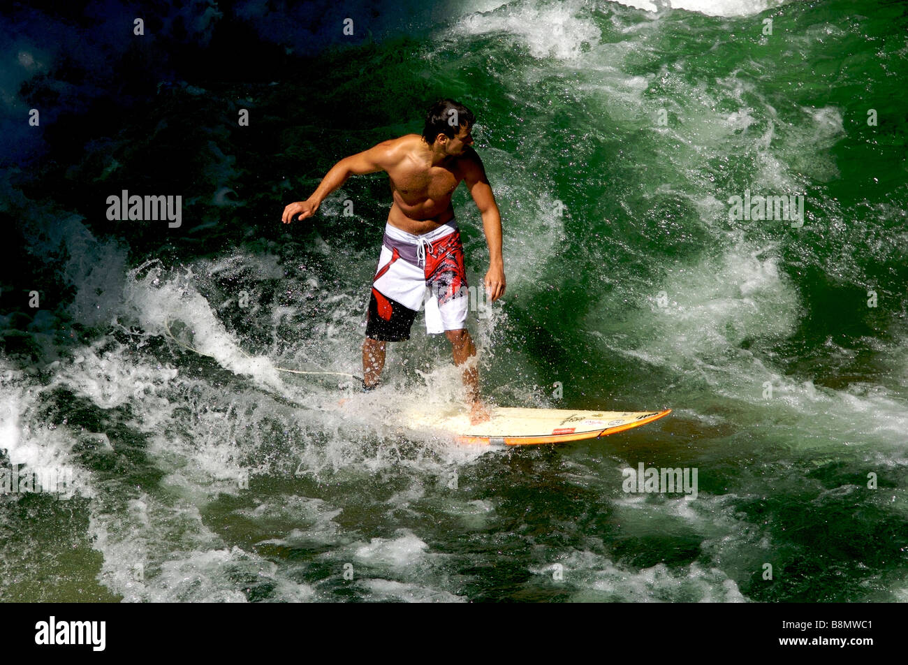 Surfer riding standing wave on the Eisbach river Munich Bavaria Germany ...