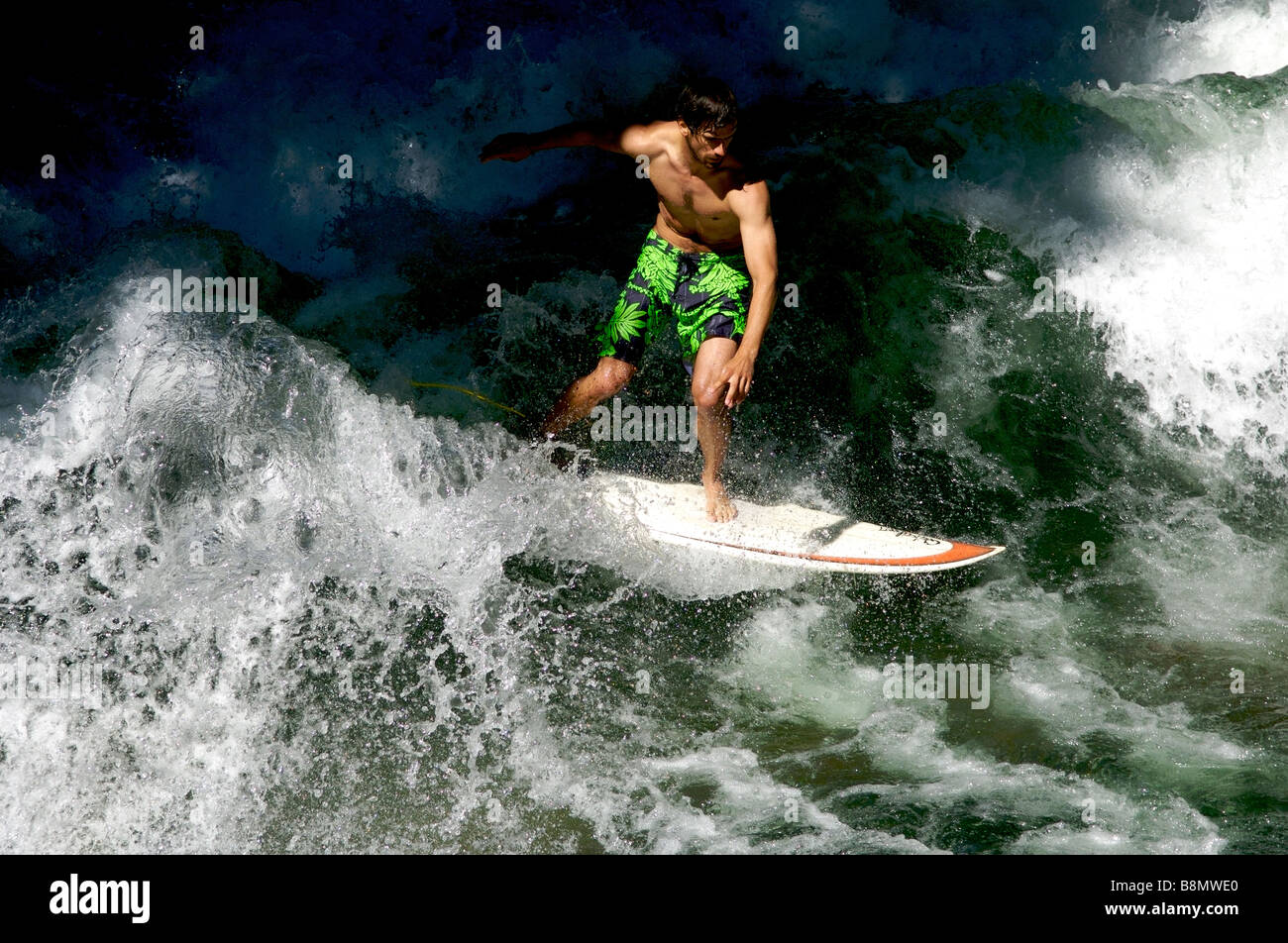 Surfer riding standing wave on the Eisbach river Munich Bavaria Germany ...