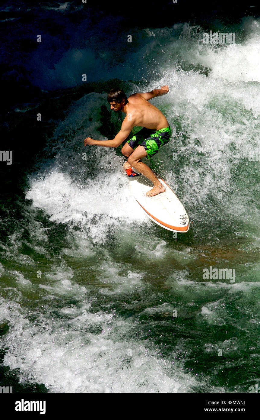 Surfer riding standing wave on the Eisbach river Munich Bavaria Germany ...