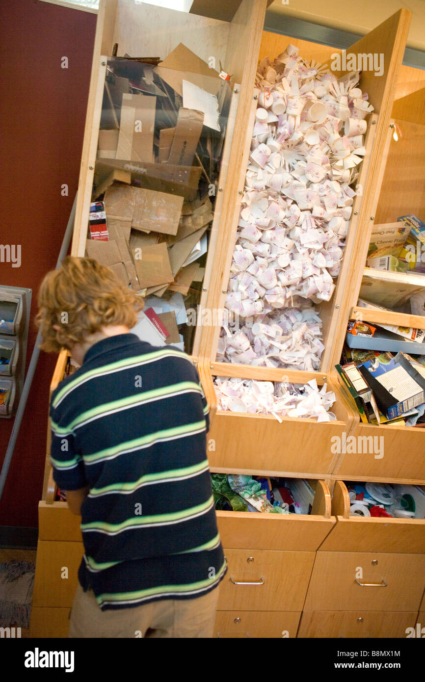 eight year old boy selecting recycled materials to use for an art ...