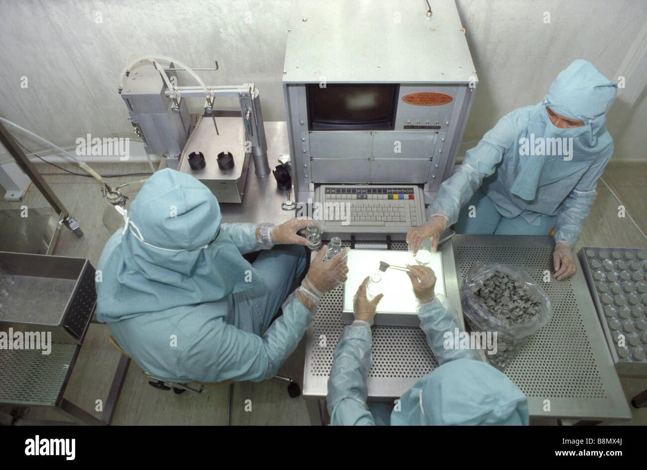 cap of glass bottle removing with forceps, sterilisation Stock Photo ...