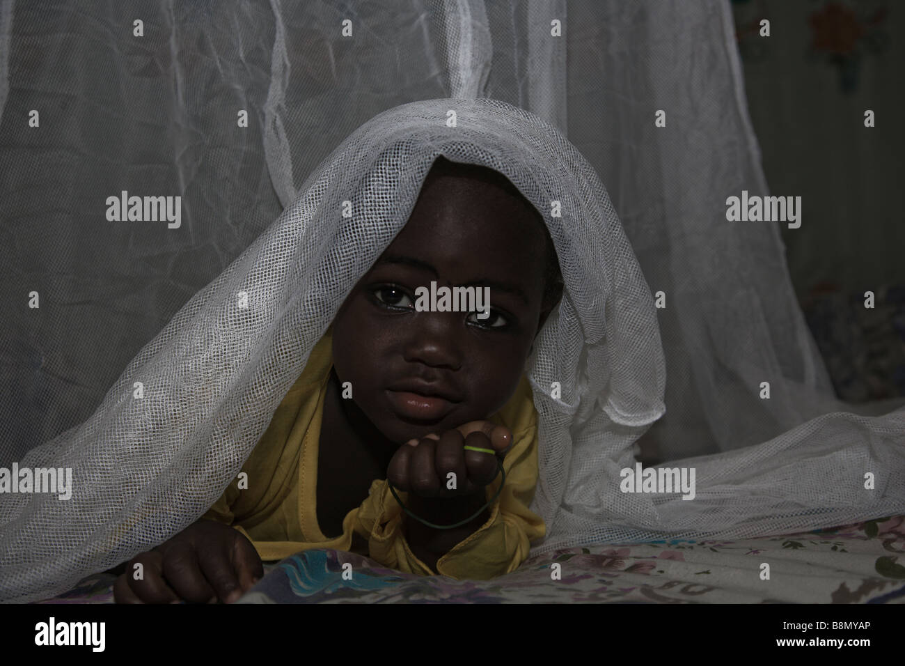 A child in Nigeria sleeps under a long lasting insecticide treated ...