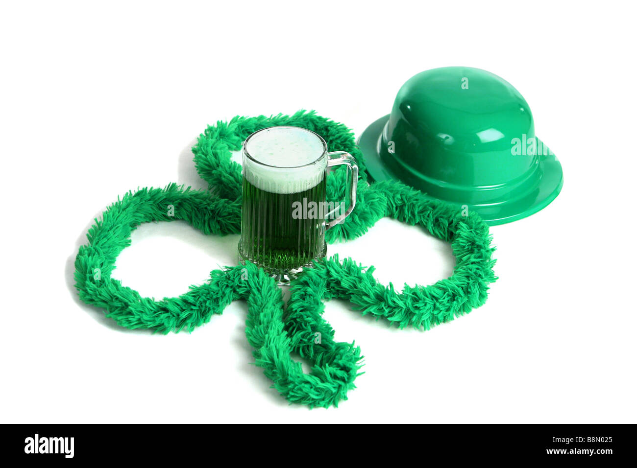 A mug of green beer with an Irish bowler hat and a green boa in the ...