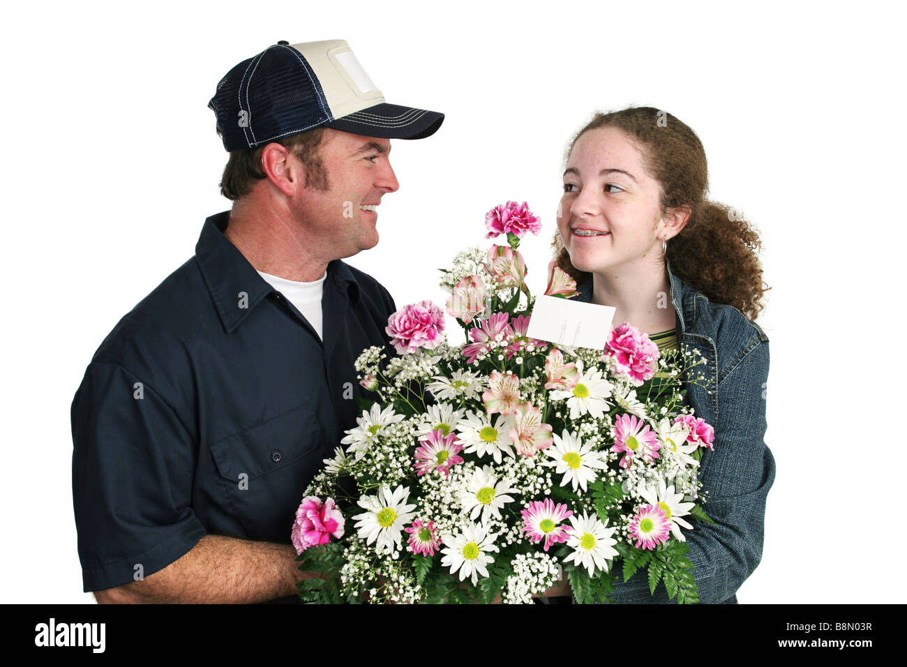 A cute teen girl receiving a bouquet of flowers from a delivery man ...