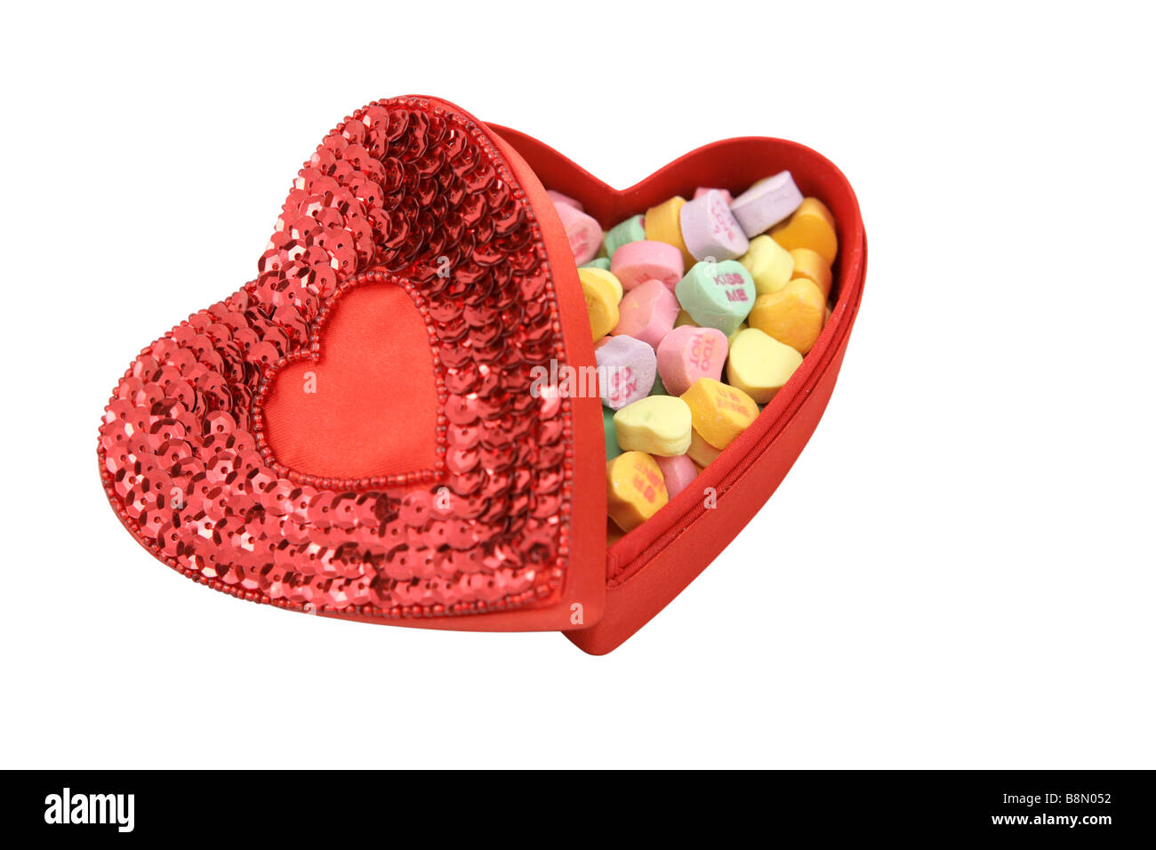 A red heart shaped box filled with Valentines candy Isolated with ...
