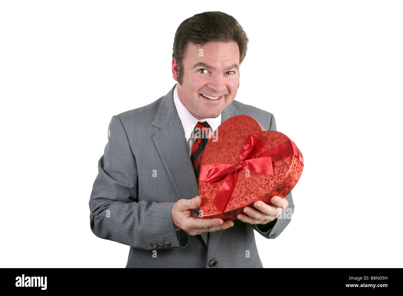 Handsome man in a suit with valentine candy Stock Photo - Alamy