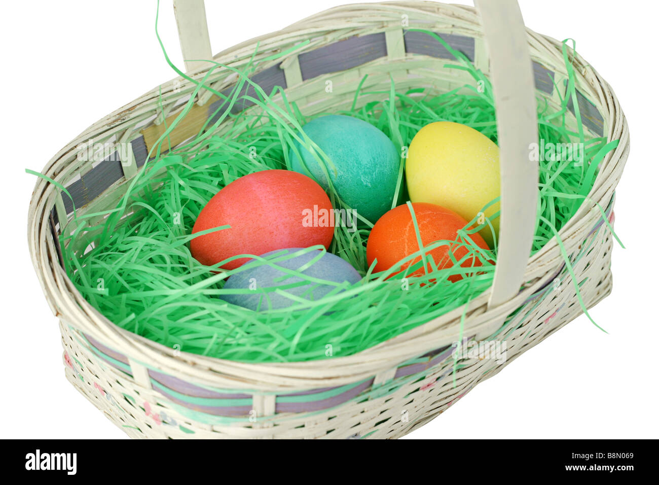 A white easter basket filled with colored eggs Isolated Stock Photo - Alamy