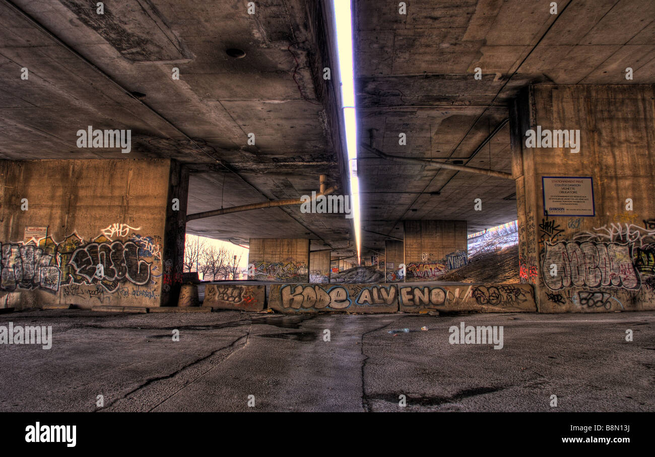 Color photograph of graffiti in an urban underpass parking lot, eerie ...