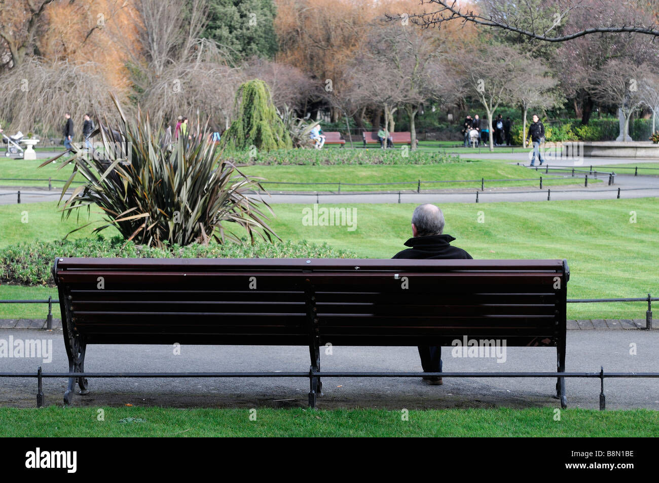 Man on bench seen behind hi-res stock photography and images - Alamy