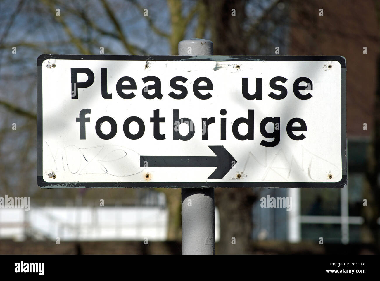 british black and white street sign requesting that pedestrians please ...