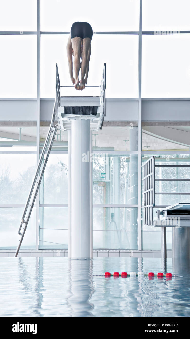 Man jumping from a highboard in an indoor swimming pool Stock Photo - Alamy