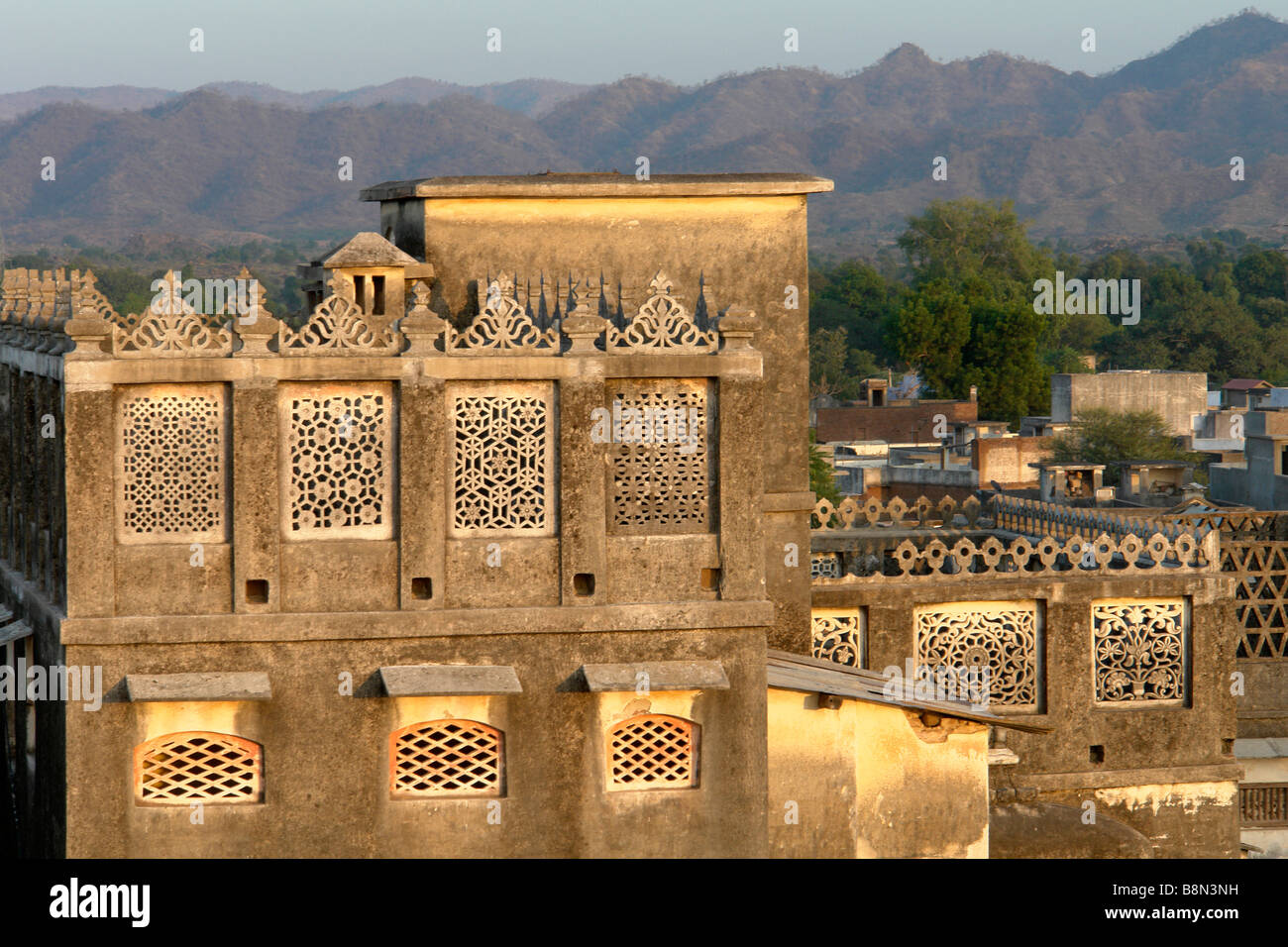 rooftop view of the ghanerao castle hotel with mountains in the ...