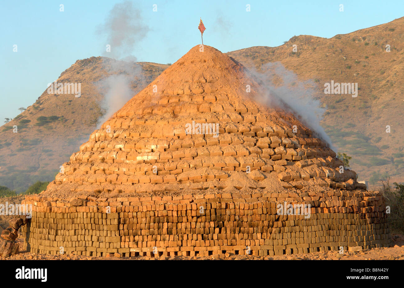 traditional indian clay brick kiln smoking by dawn light Stock Photo ...