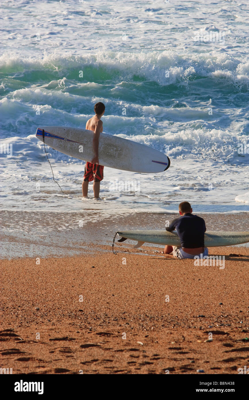 Longboarders watching the waves in the late afternoon Stock Photo - Alamy