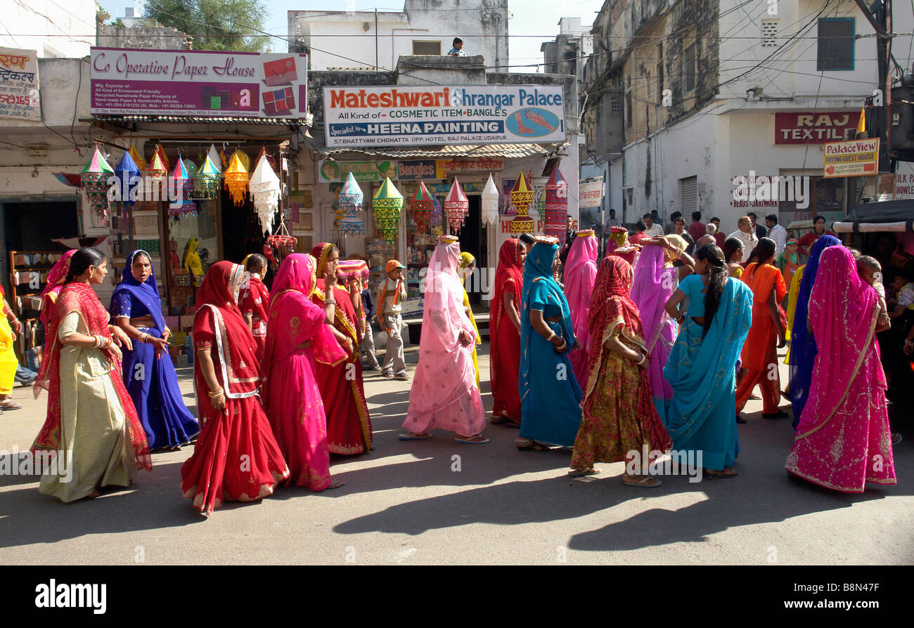 group of indian women in traditional local dress walking through the ...